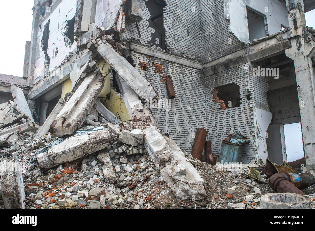 A huge pile of gray concrete debris from piles and stones of the ...