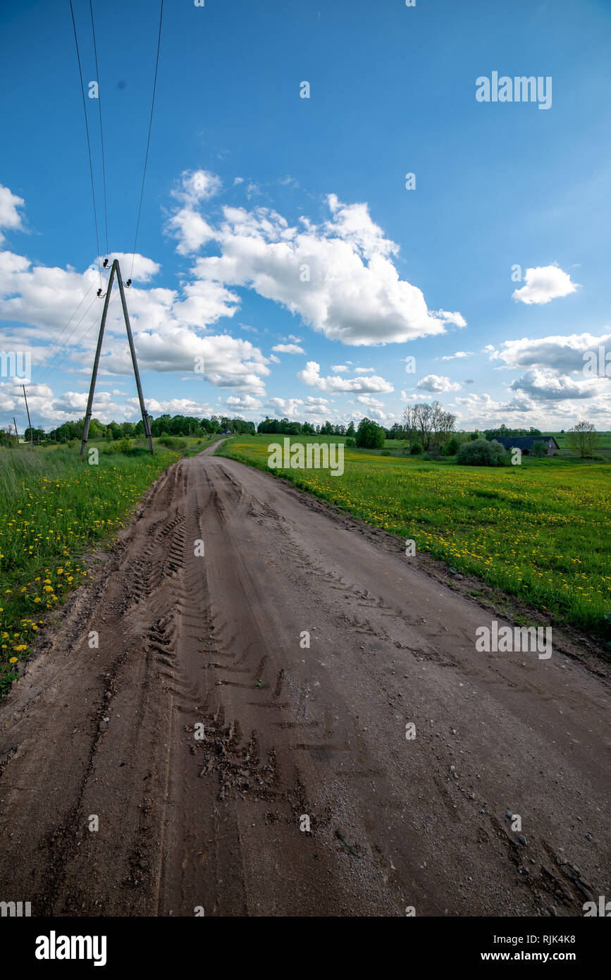empty country gravel road with mud puddles and bumps. dirty road ...