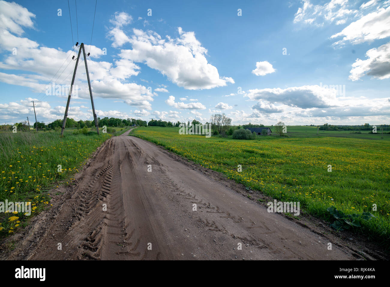empty country gravel road with mud puddles and bumps. dirty road ...