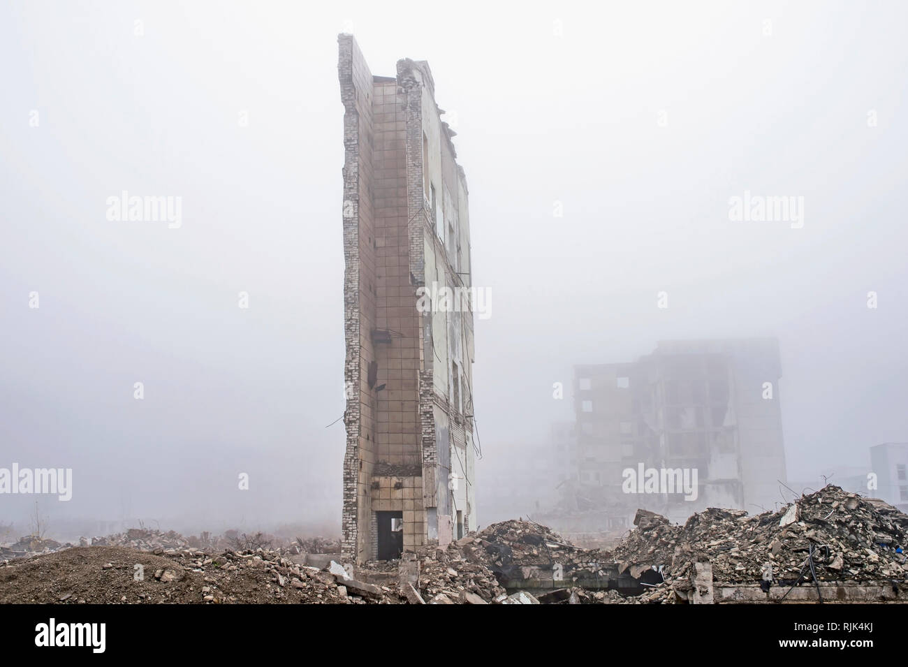 The remains of the wall of a large destroyed building against the ...