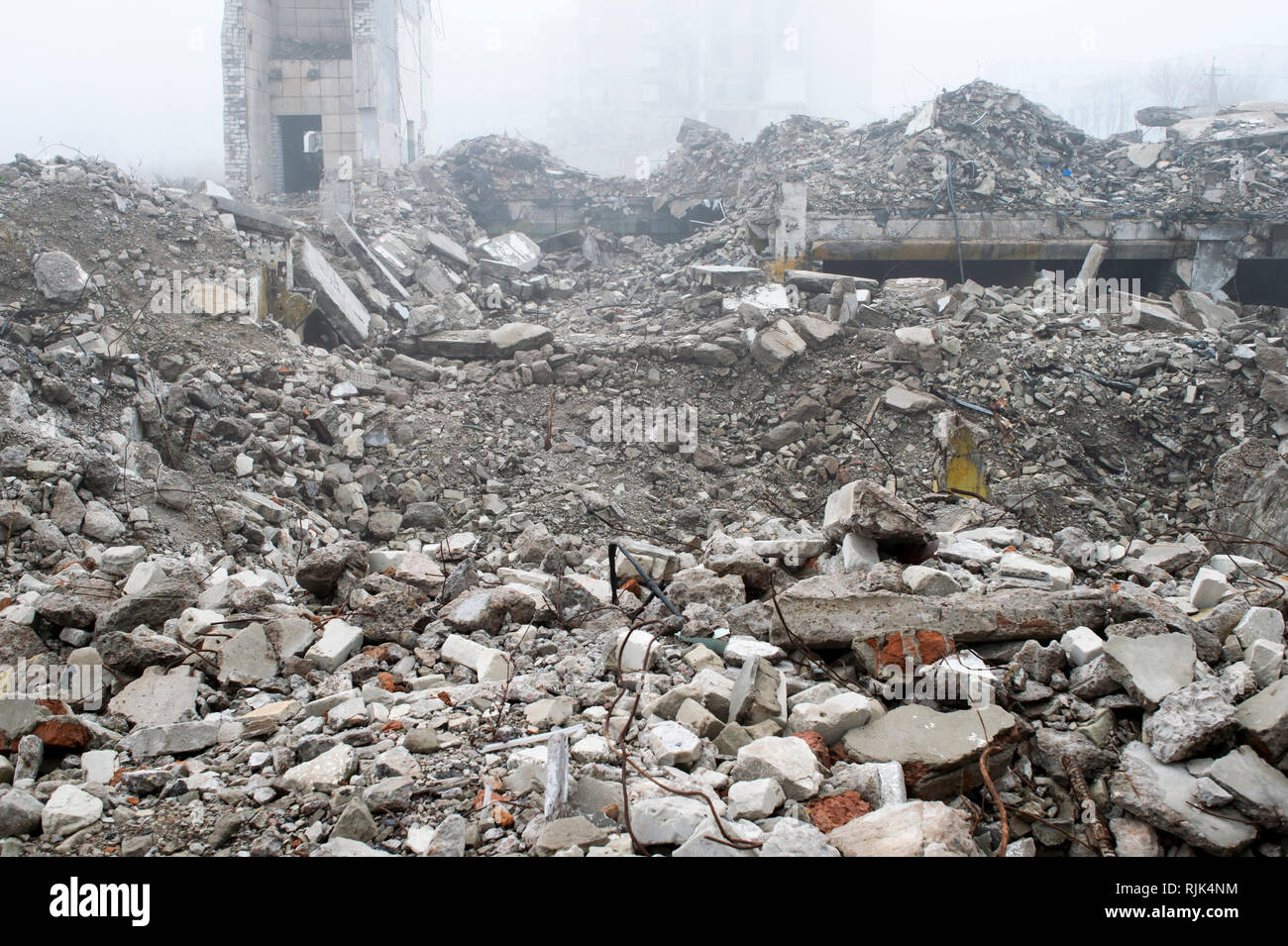 A huge pile of gray concrete debris from piles and stones of the ...