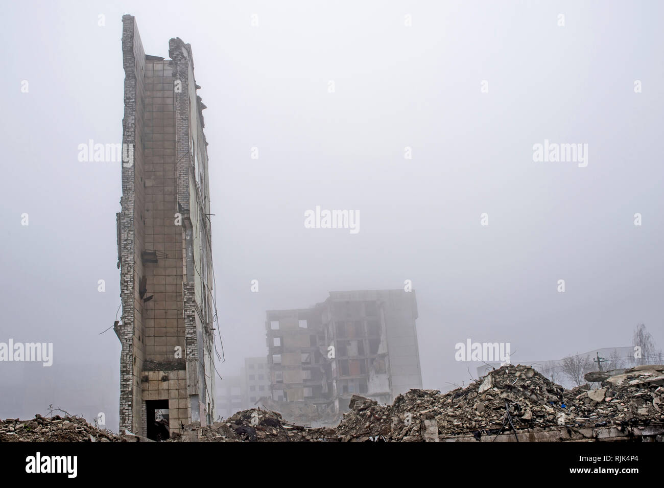 The remains of the wall of a large destroyed building against the ...