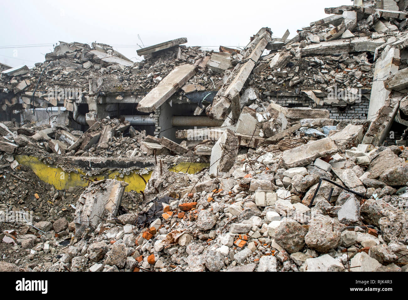 A huge pile of gray concrete debris from piles and stones of the ...