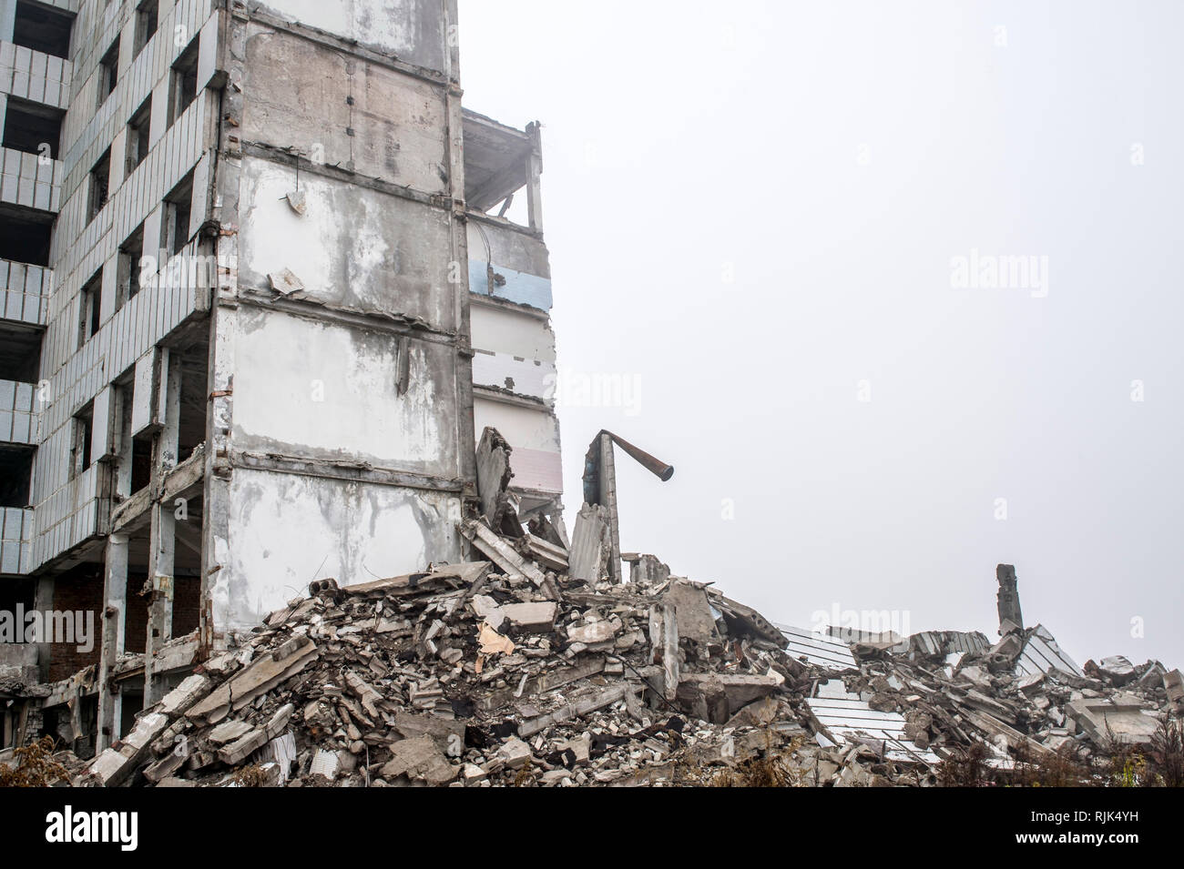 A huge pile of gray concrete debris from piles and stones of the ...