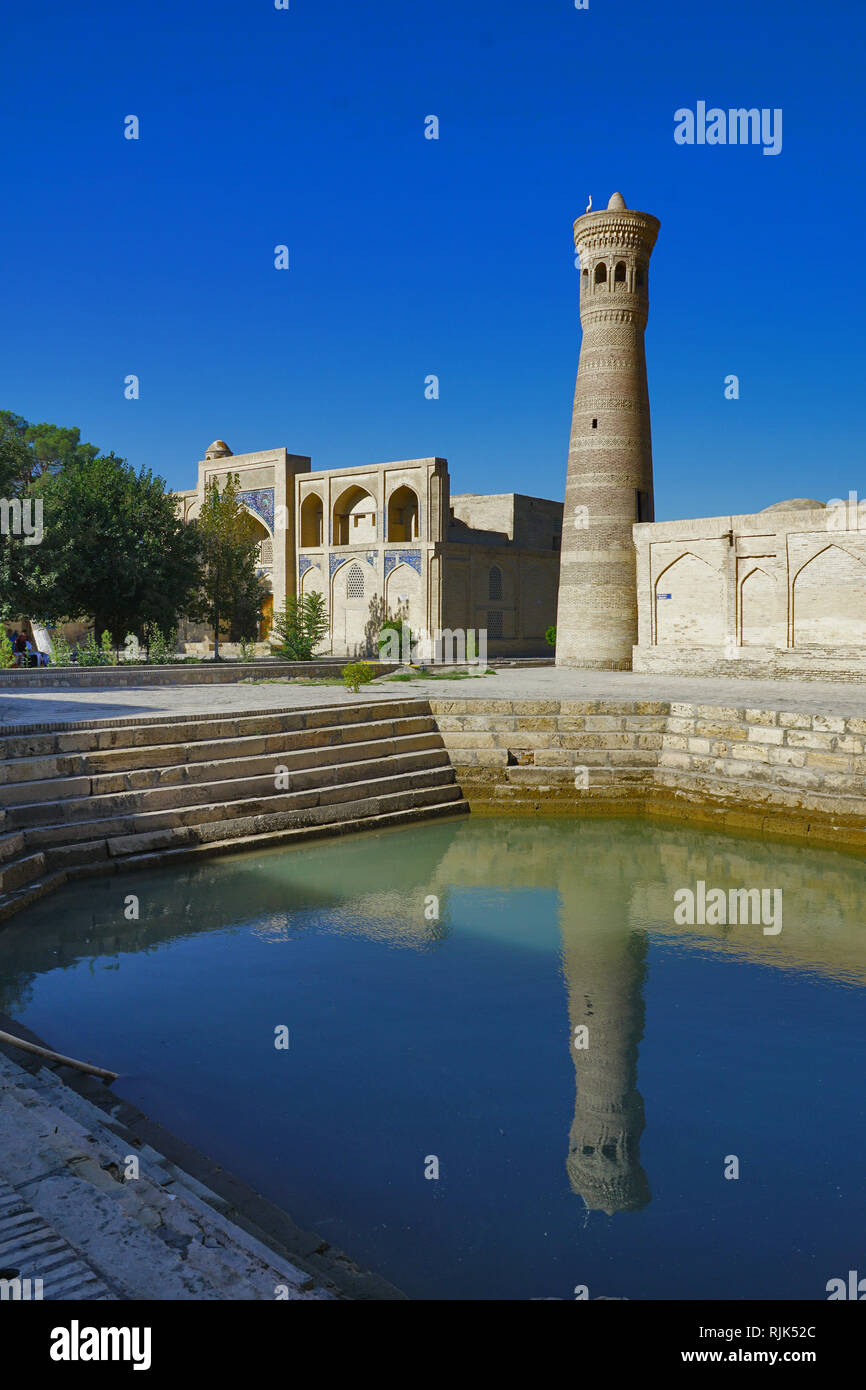 Mosque with minaret reflected in the lake - Bukhara, Uzbekistan Stock ...