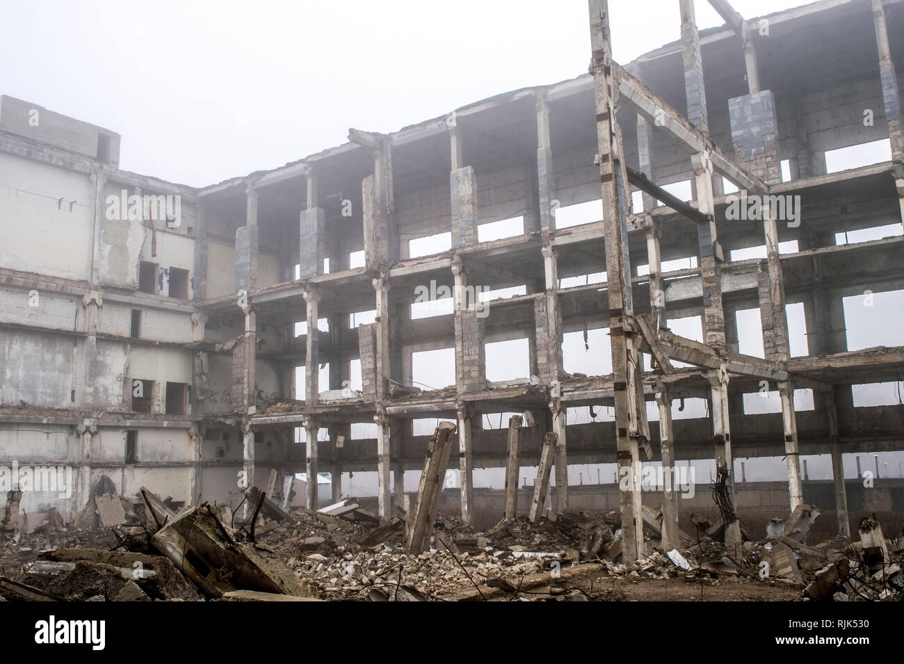 Frame of concrete piles of a large building in a thick foggy haze. The ...
