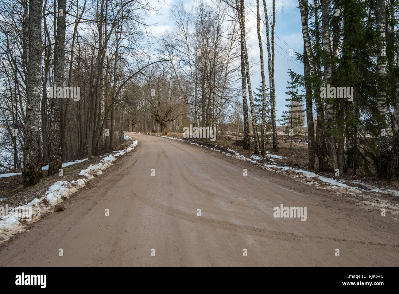 empty country gravel road with mud puddles and bumps. dirty road ...
