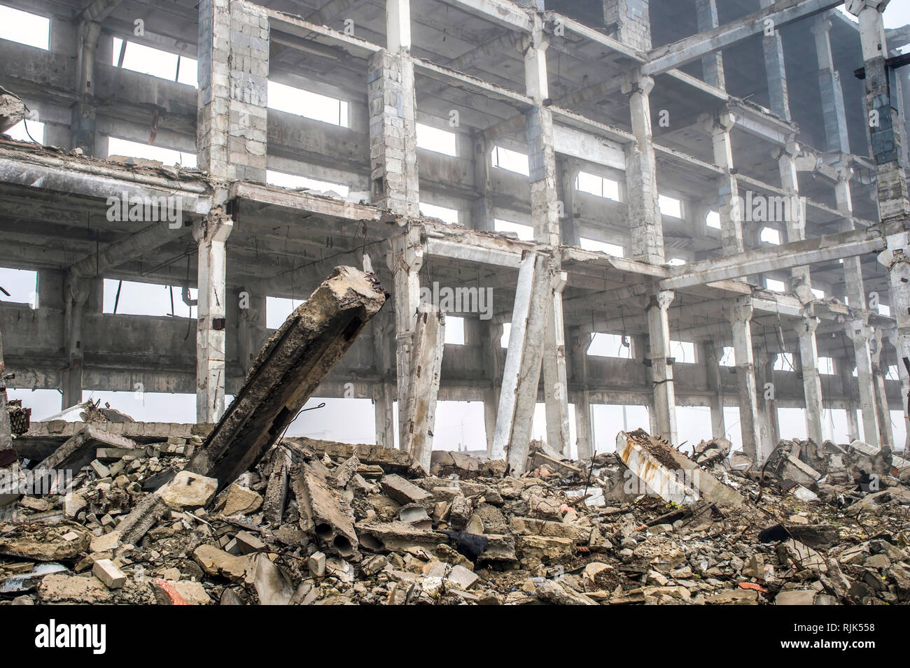 A huge concrete beam sticking out of a pile of concrete debris on the ...