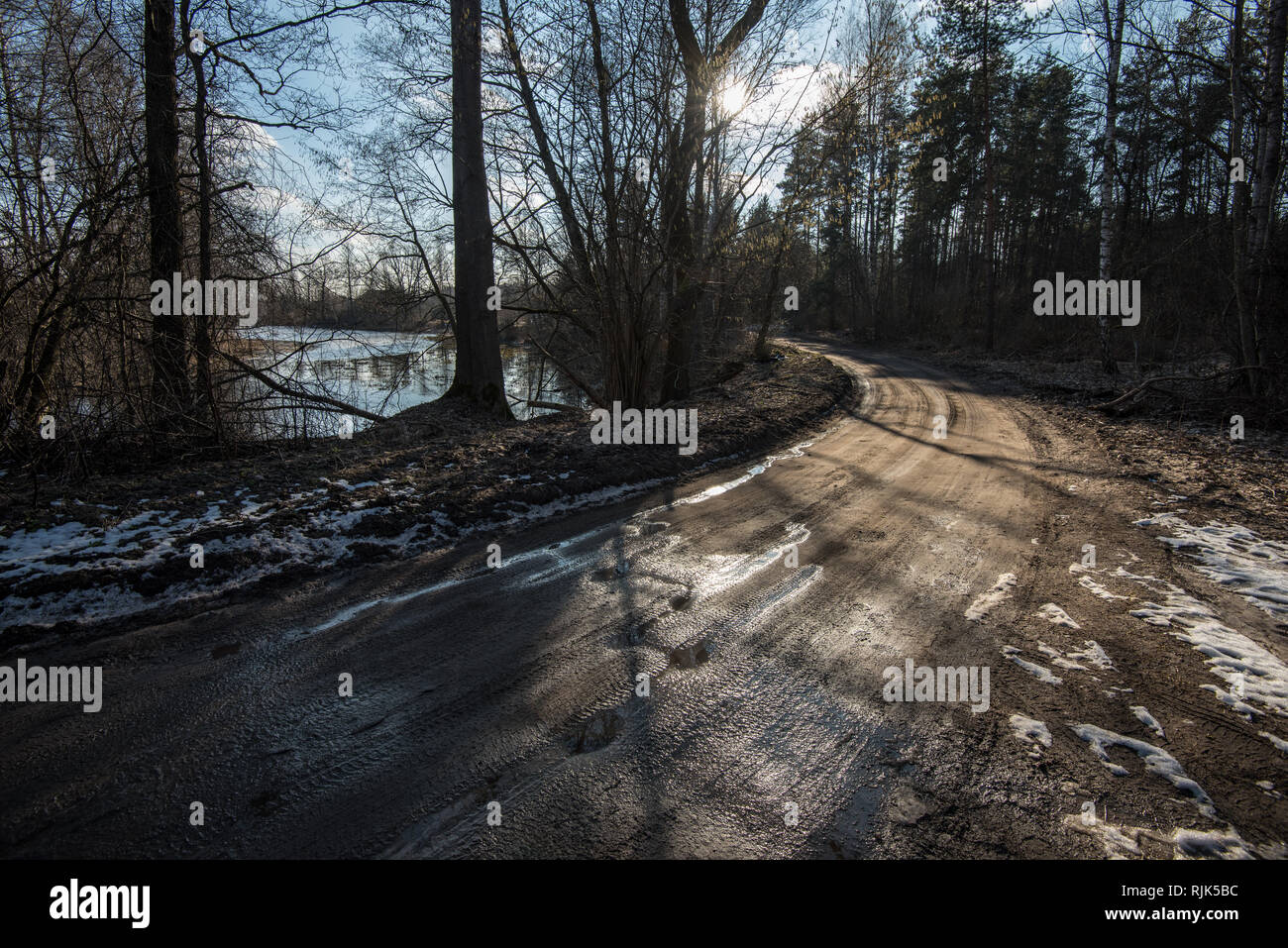 empty country gravel road with mud puddles and bumps. dirty road ...