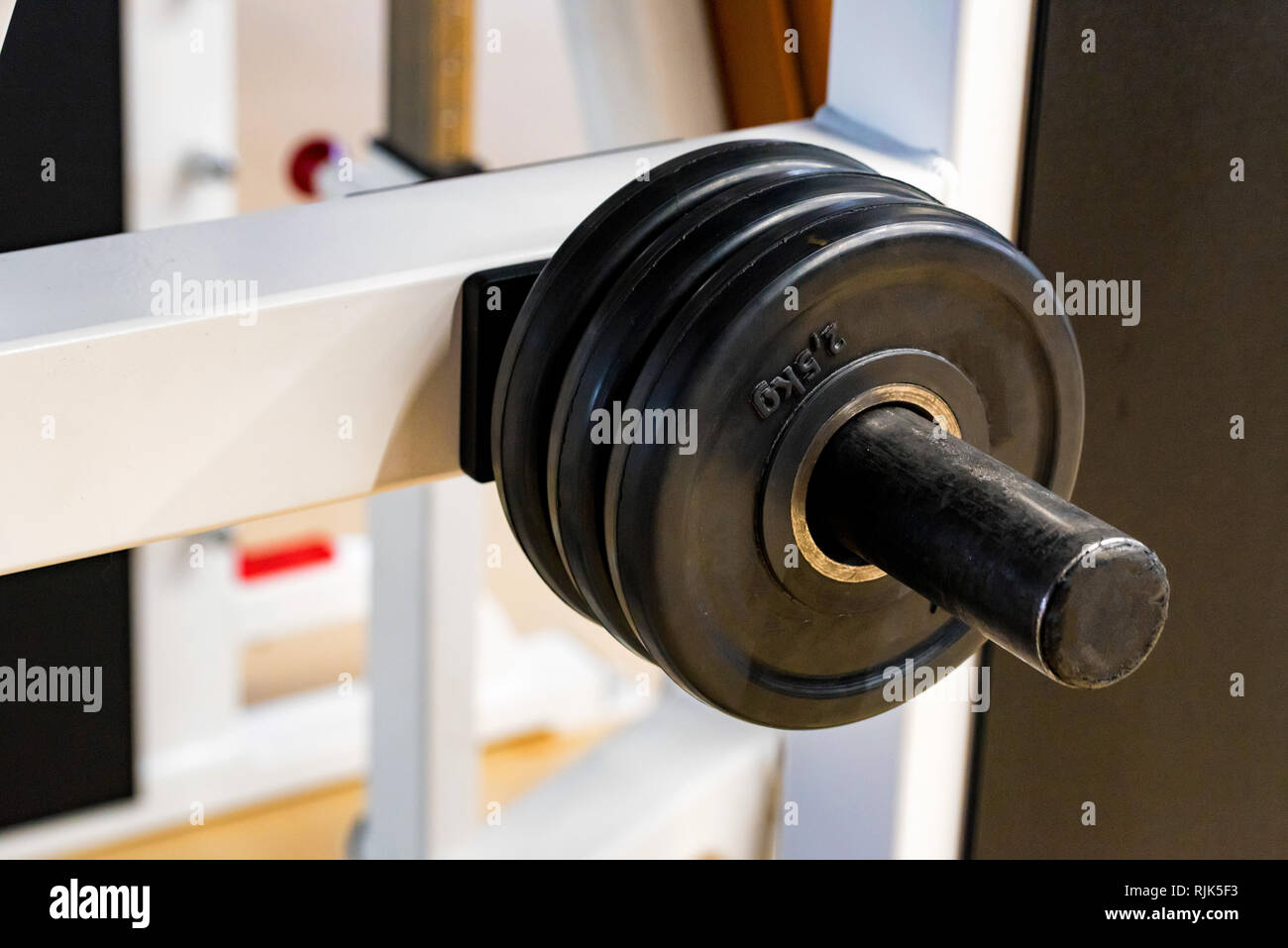 Fitness dumbbell and barbell weight plates in gym close Stock Photo - Alamy