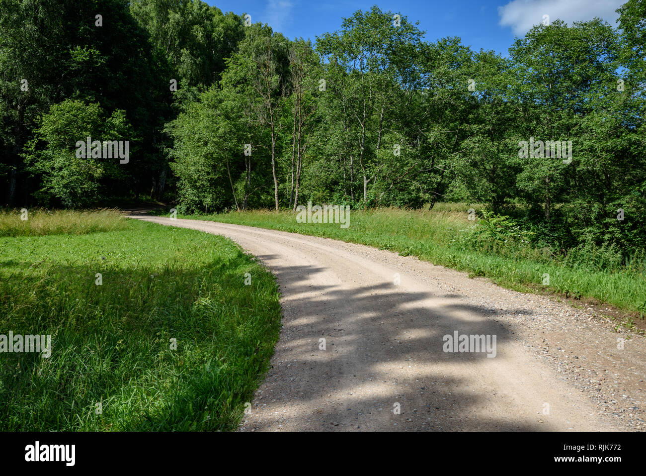 empty country gravel road with mud puddles and bumps. dirty road ...