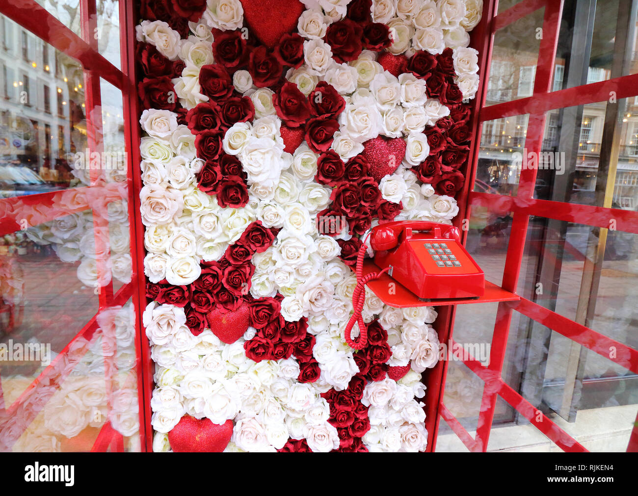 Valentines Day 'Call me Love' display of roses around a telephone box ...