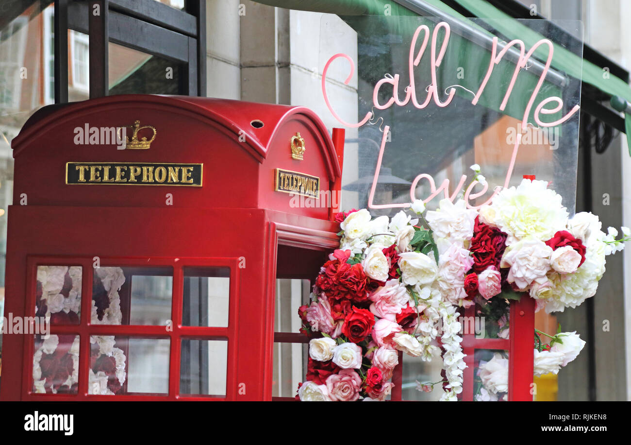 Valentines Day 'Call me Love' display of roses around a telephone box ...