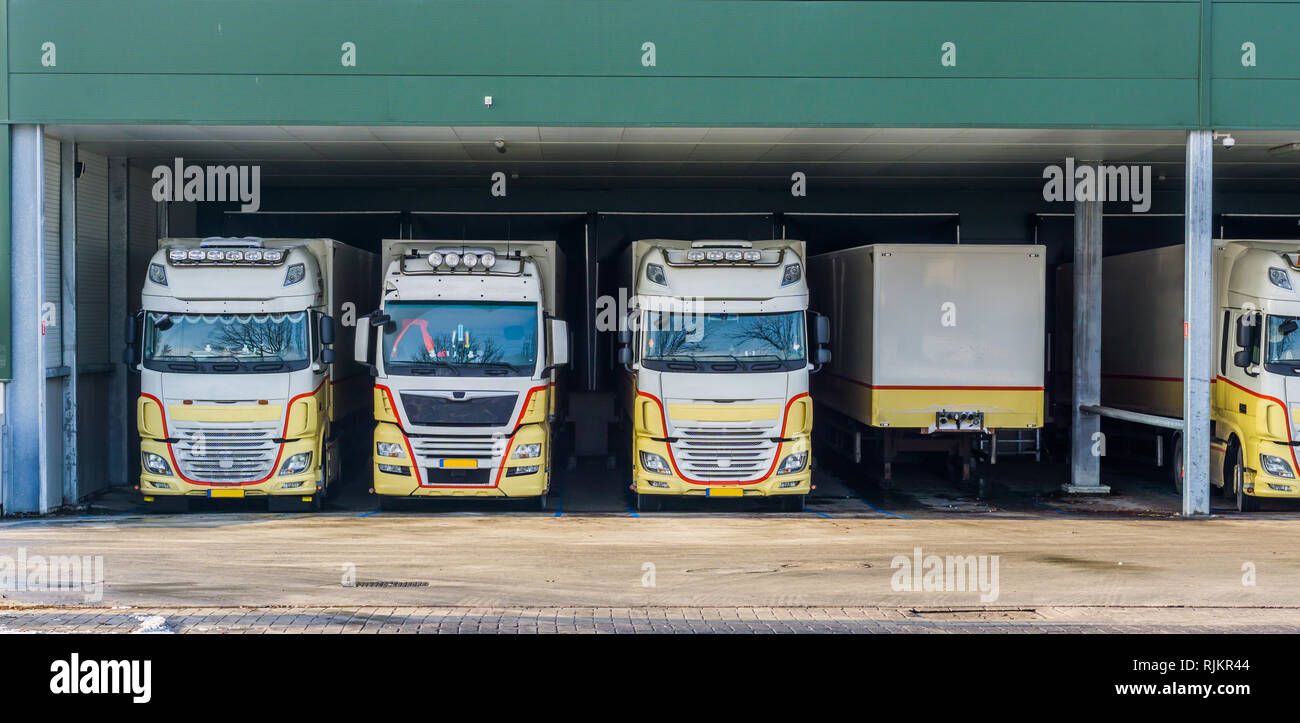 parked trucks at a docking station of a warehouse, logistics and ...
