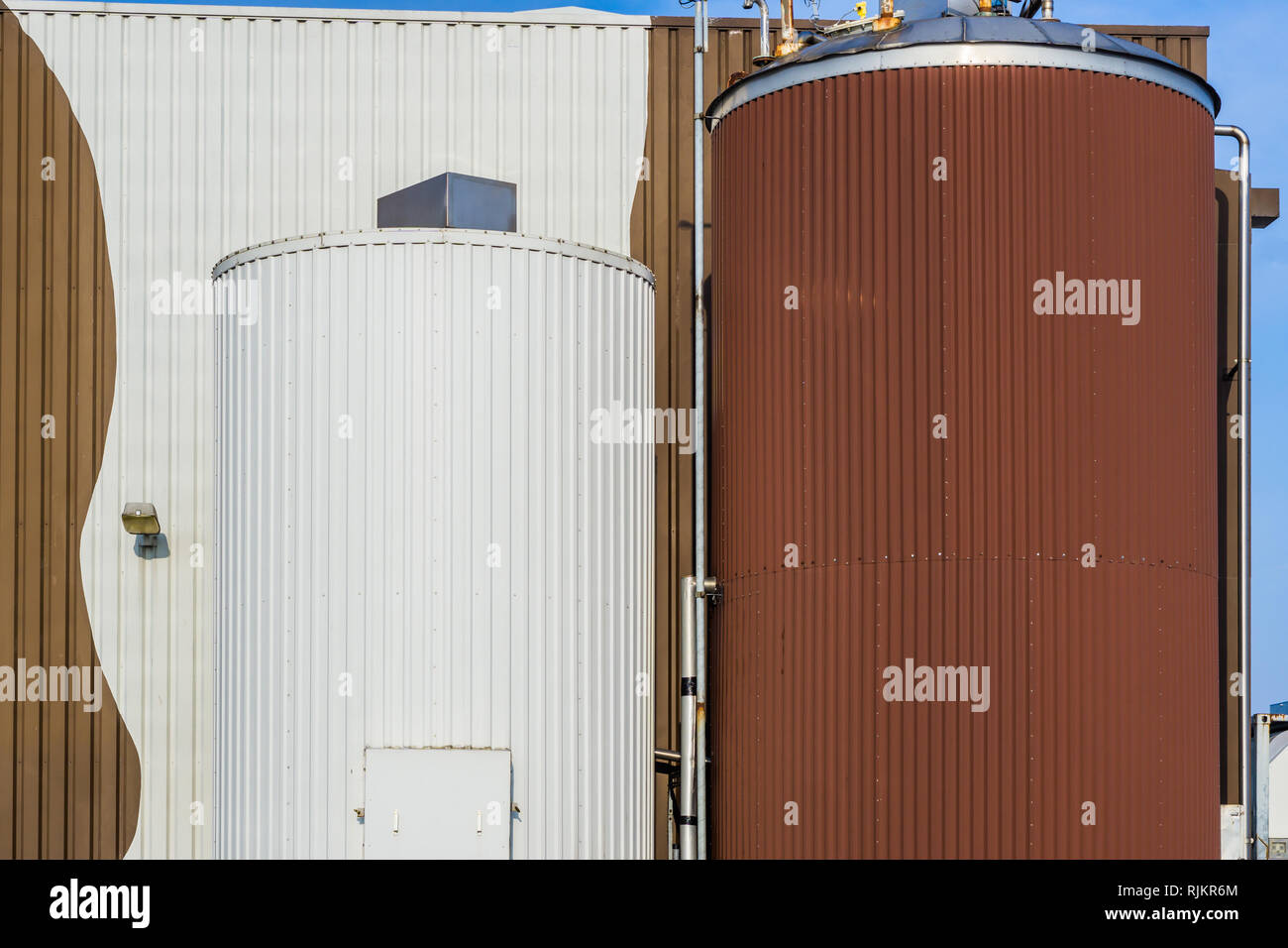two liquid tanks in brown and white, industry background, industrial ...