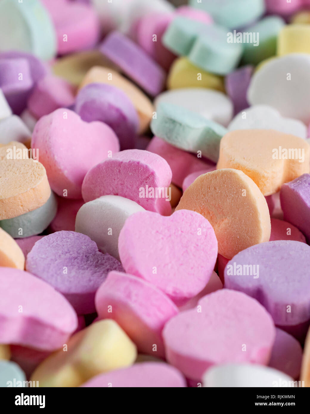 Assortment of candy hearts. Blurry background Stock Photo - Alamy