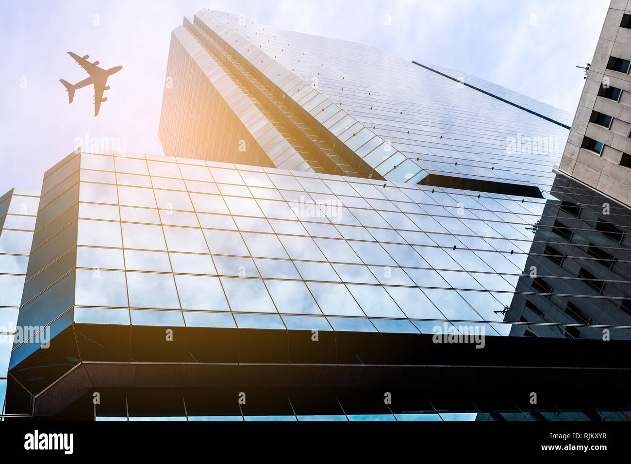 Bottom angle view of airplane in sky over city buildings Stock Photo ...