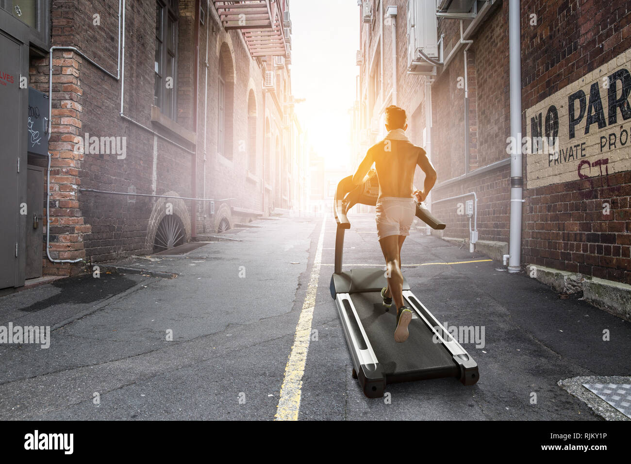 Back view of man athlete running on treadmill. Mixed media Stock Photo ...