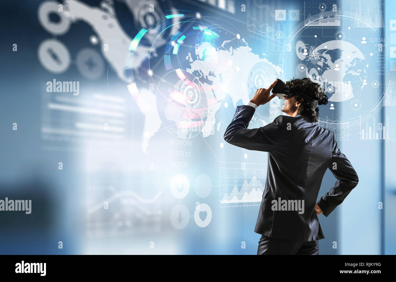 Businessman wearing virtual mask and using media panel. Mixed media ...