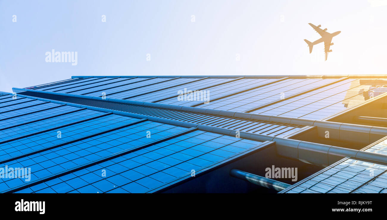 Bottom angle view of airplane in sky over city buildings Stock Photo ...