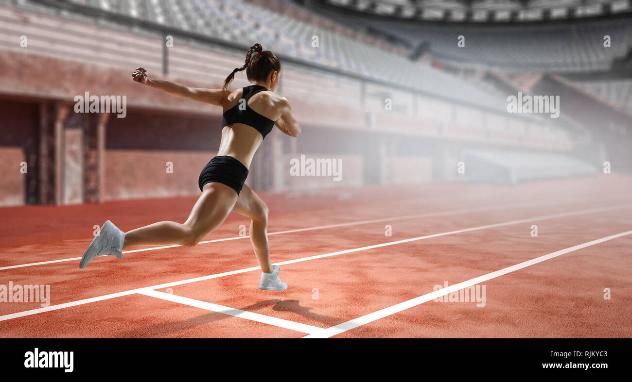Athletic woman running on track at stadium. Mixed media Stock Photo - Alamy