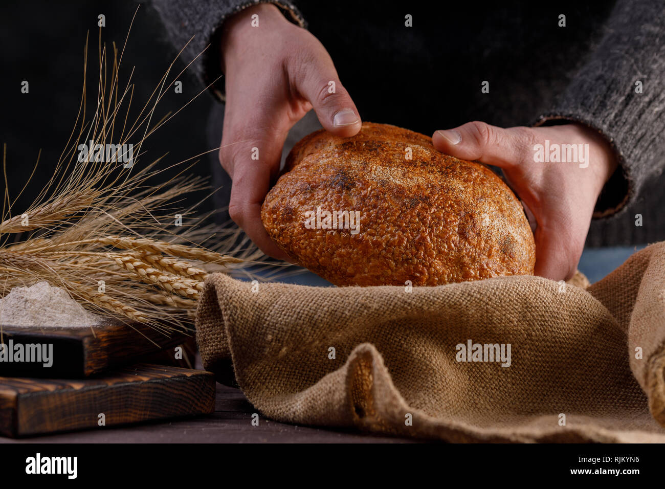 Craft bread in the hands of a man close-up. The concept of healthy food ...