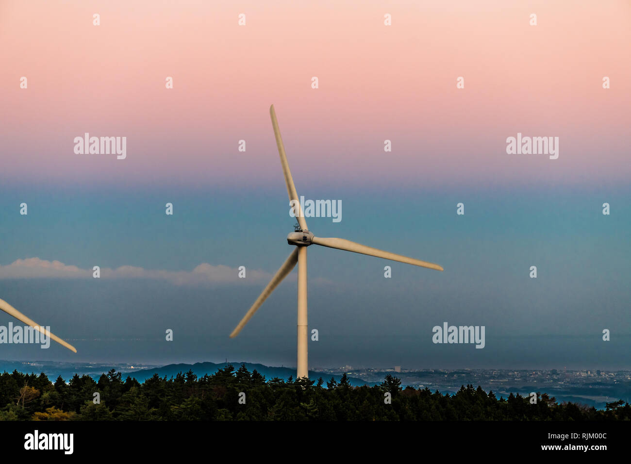Twilight time. The wind power generators standing at the hill top ...