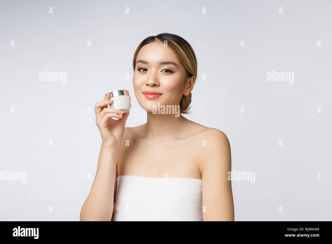 Beautiful Asia woman presenting product isolated on white background ...