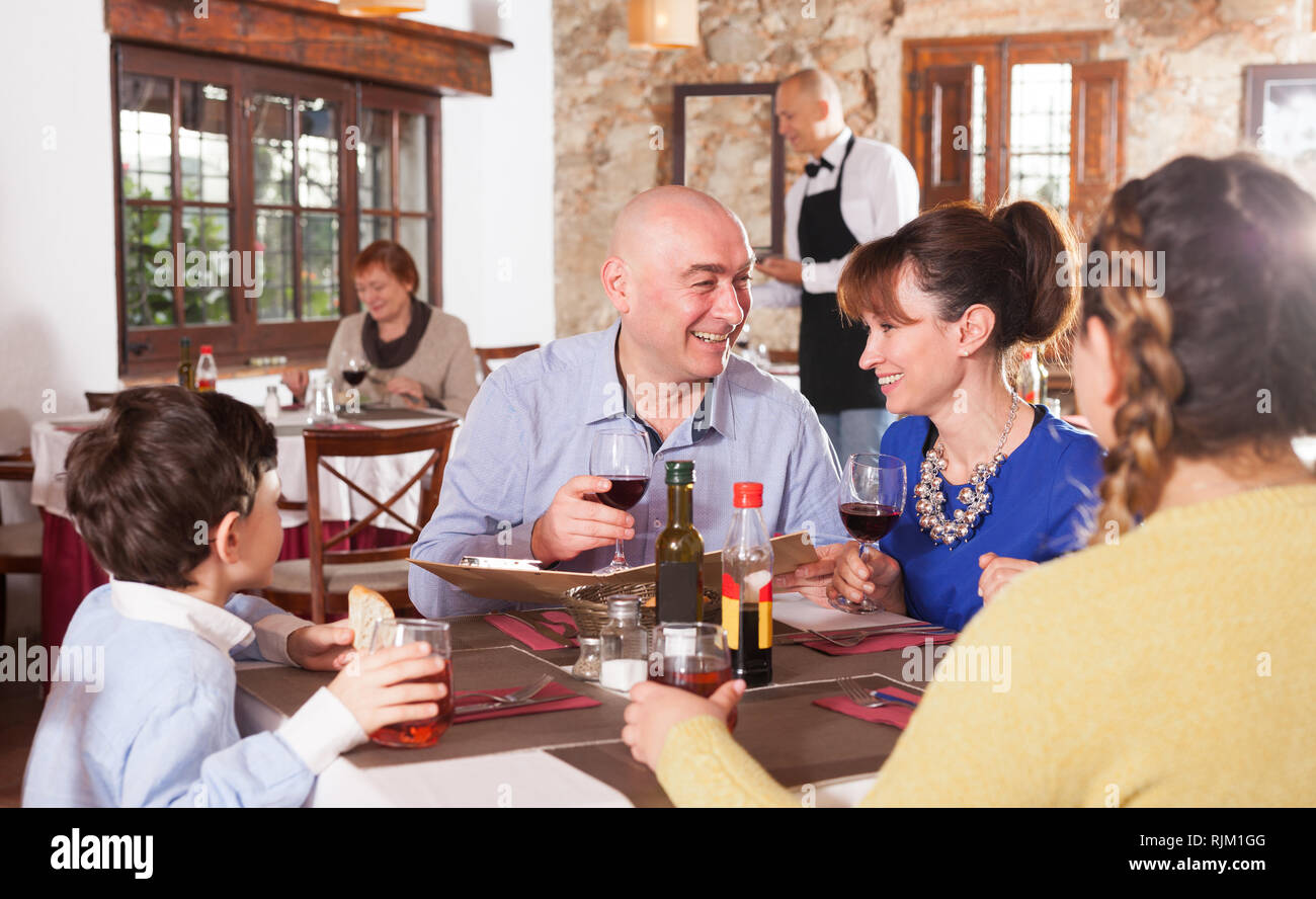 Happy family with little boy eating out together at restaurant Stock ...