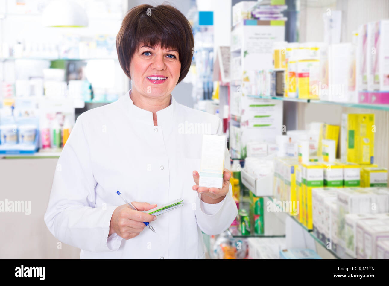 portrait of woman pharmacist wearing uniform and working in ...