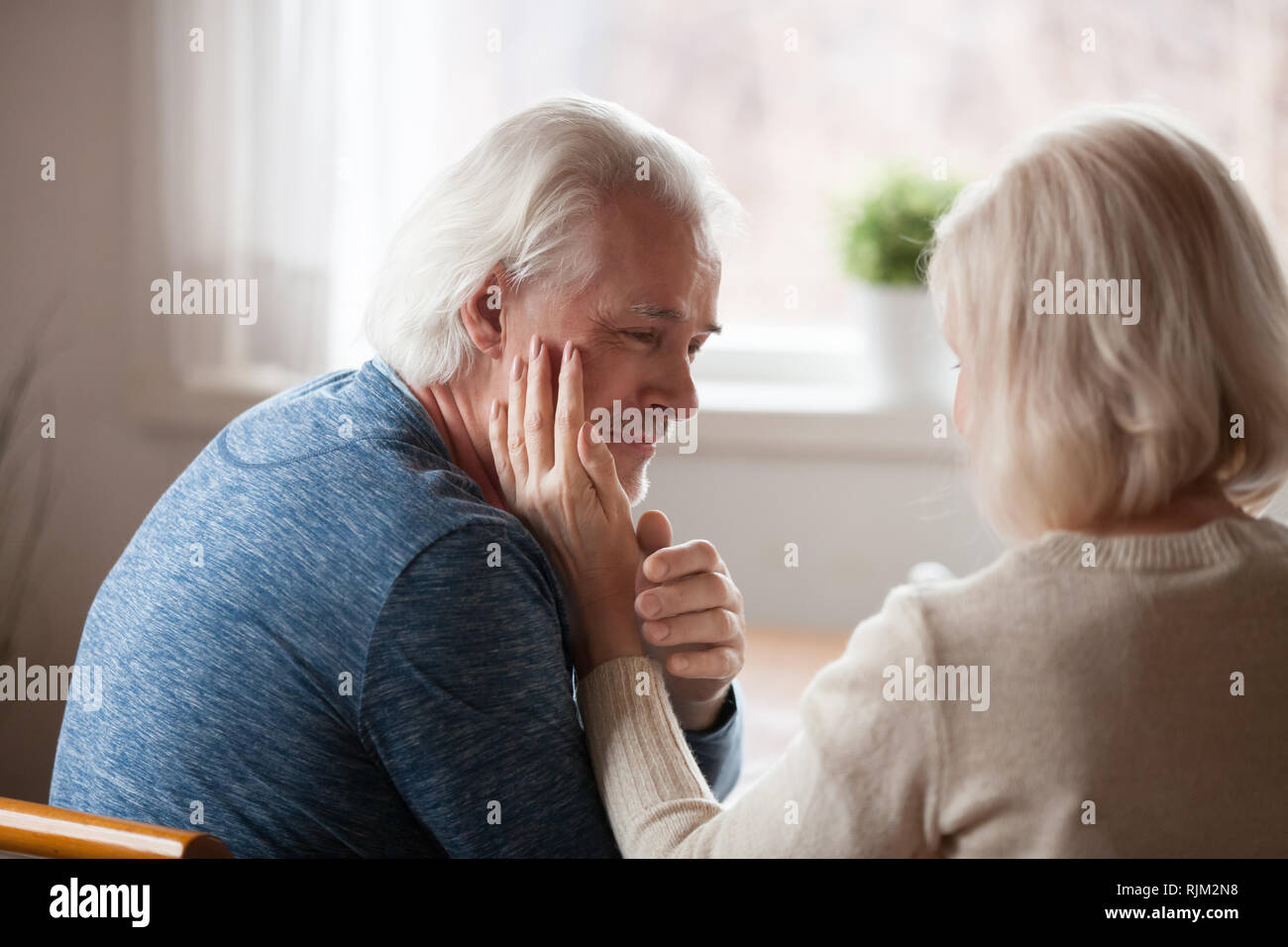Attractive aged married couple looking with love each other Stock Photo ...