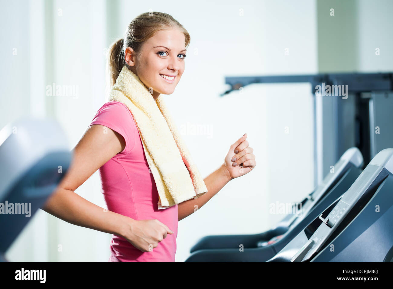 Happy woman exercising in gym Stock Photo - Alamy