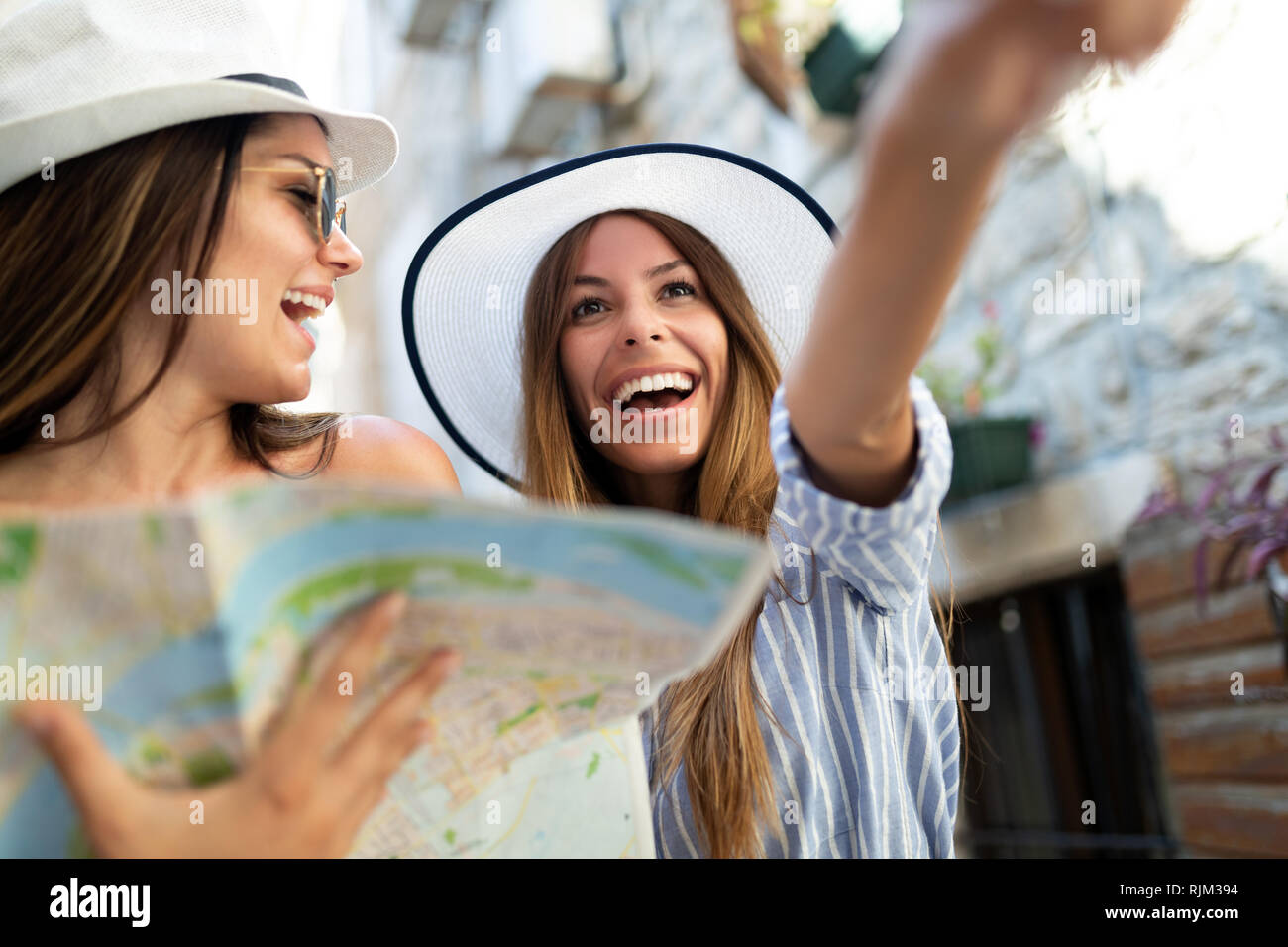 Group of friends tourists with map in old city on vacation Stock Photo ...