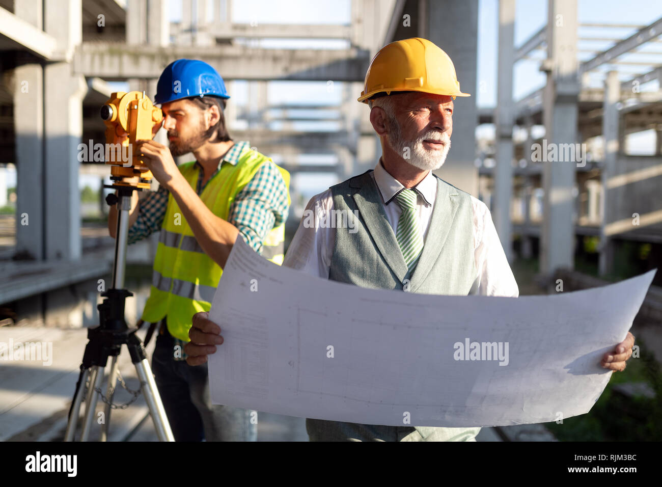 Two construction engineer working in construction site Stock Photo - Alamy