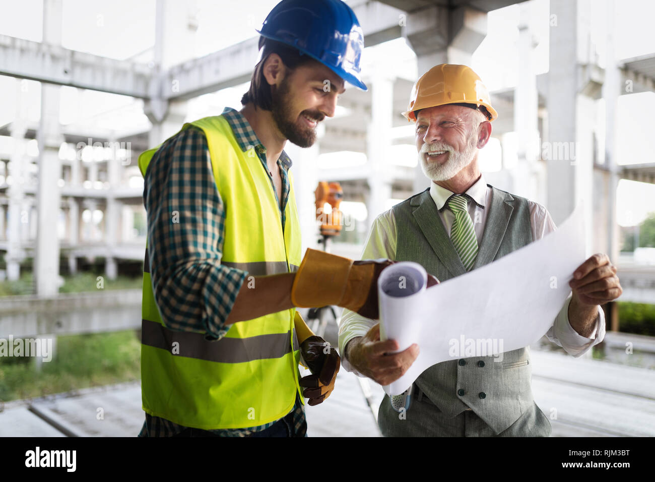 Construction engineer with foreman worker checking construction site ...