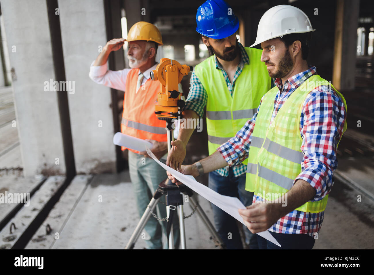 Construction engineers discussion with architects at construction or ...