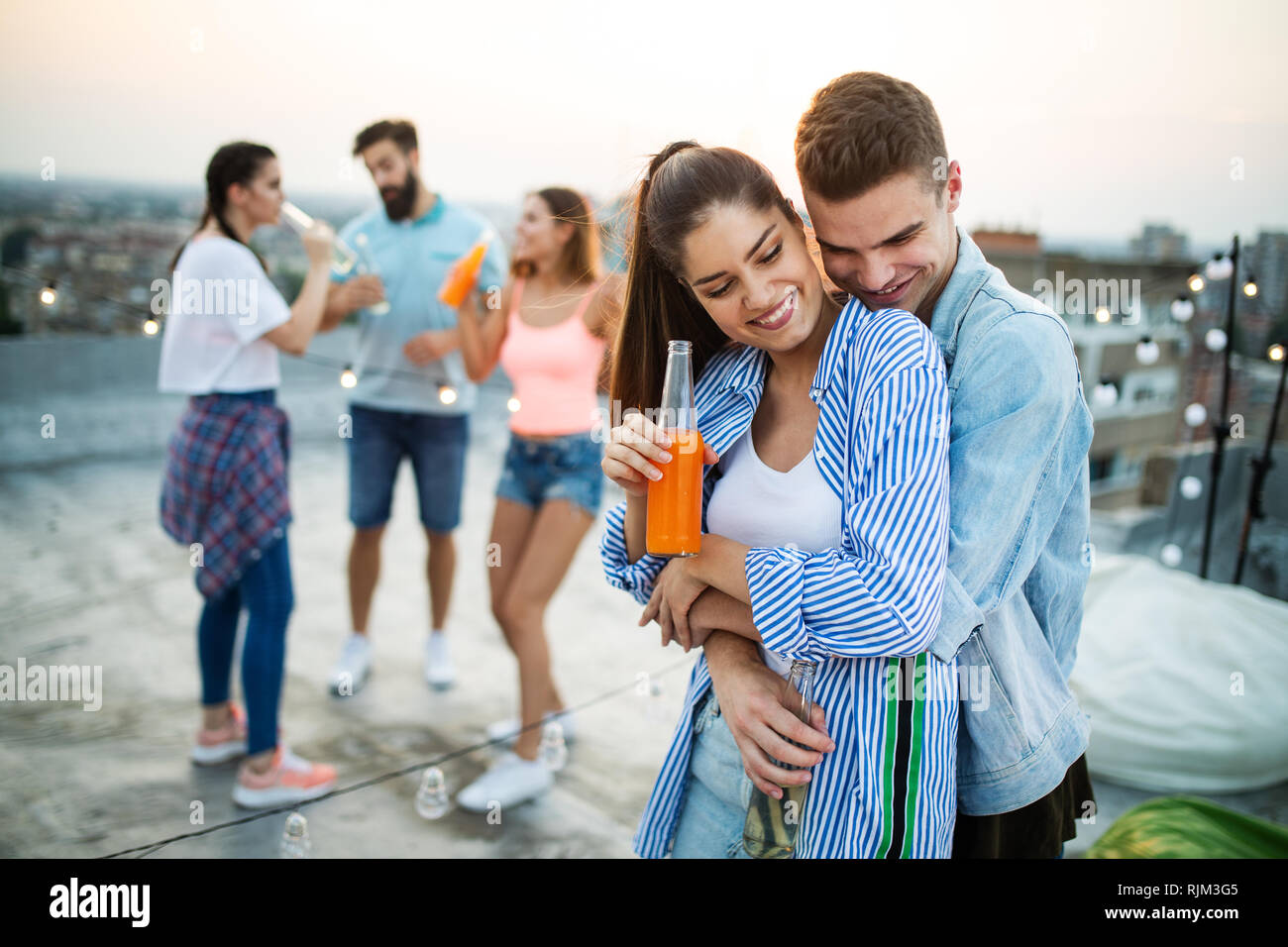 Friends having party on top of the roof. Fun, summer, city lifestyle ...
