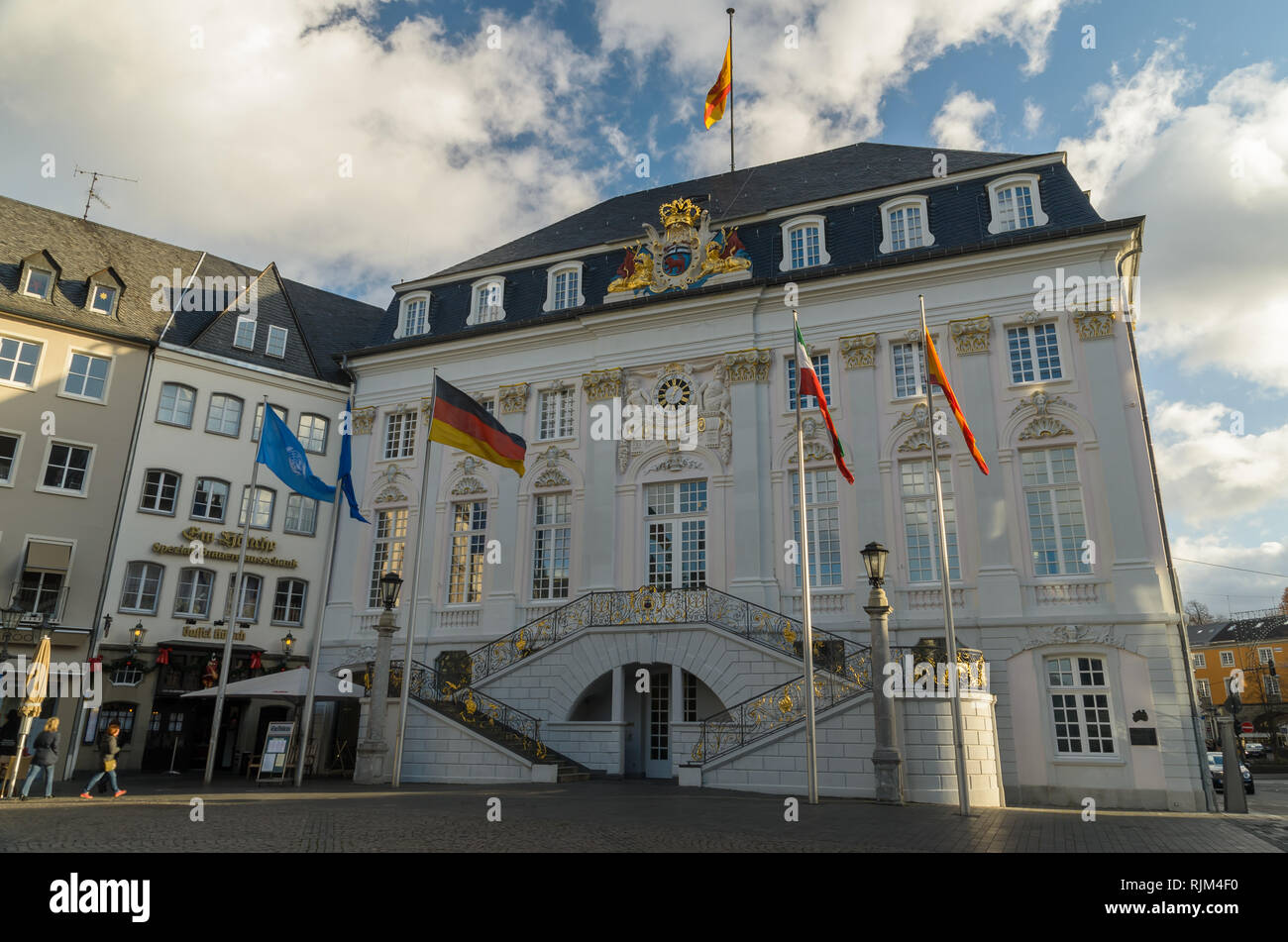 German flag waves against the blue sky in front of the Bundesstadt Bonn ...