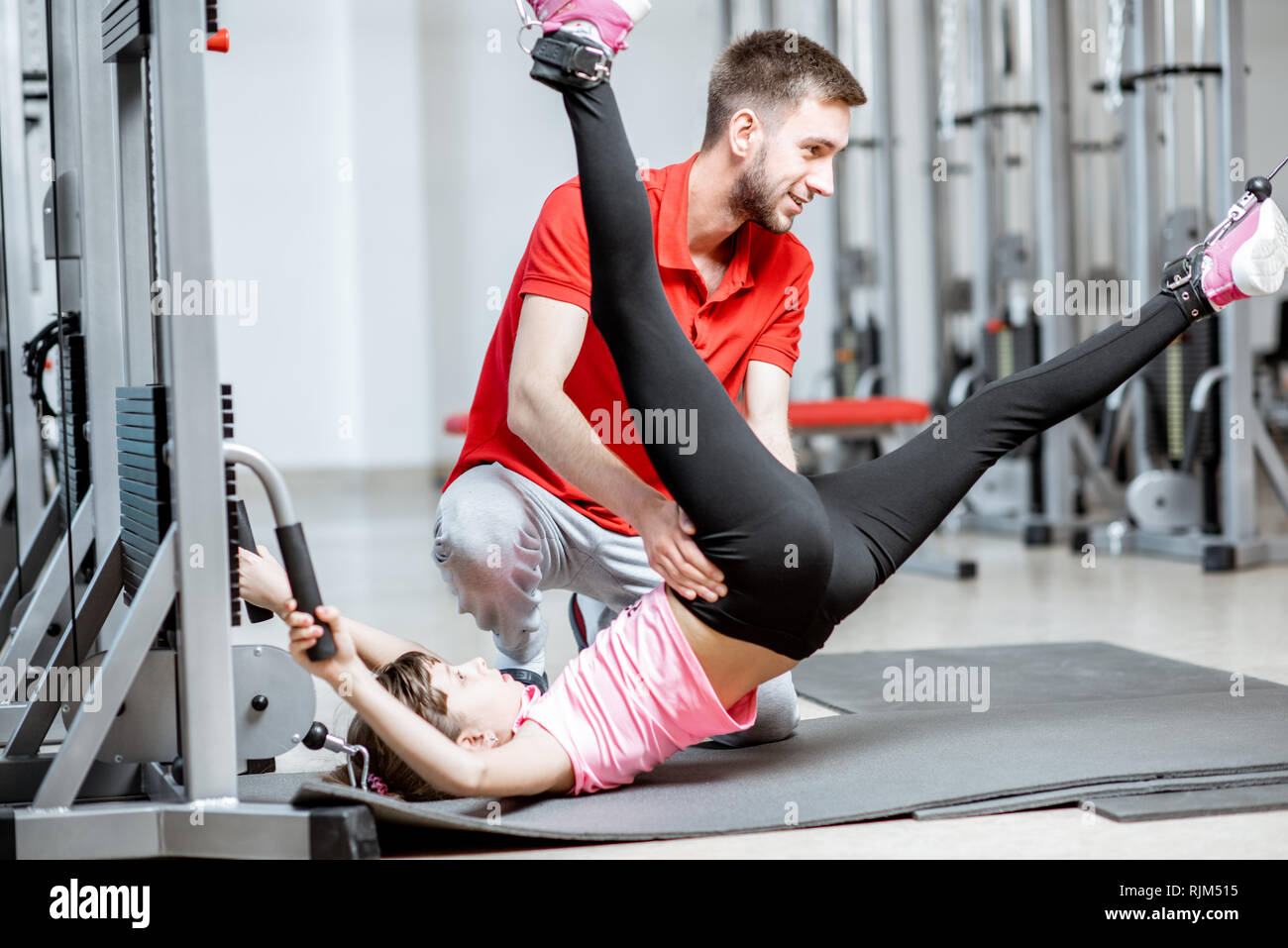 Young girl exercising on the decompression simulators with trainer ...