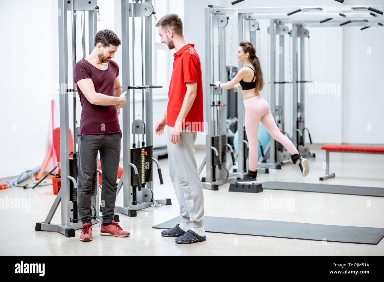 Therapist talking with man patient having problems with his back ...