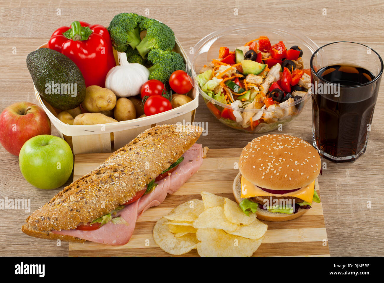 Delicious fresh food on wooden table. Double cheeseburger, potato chips ...