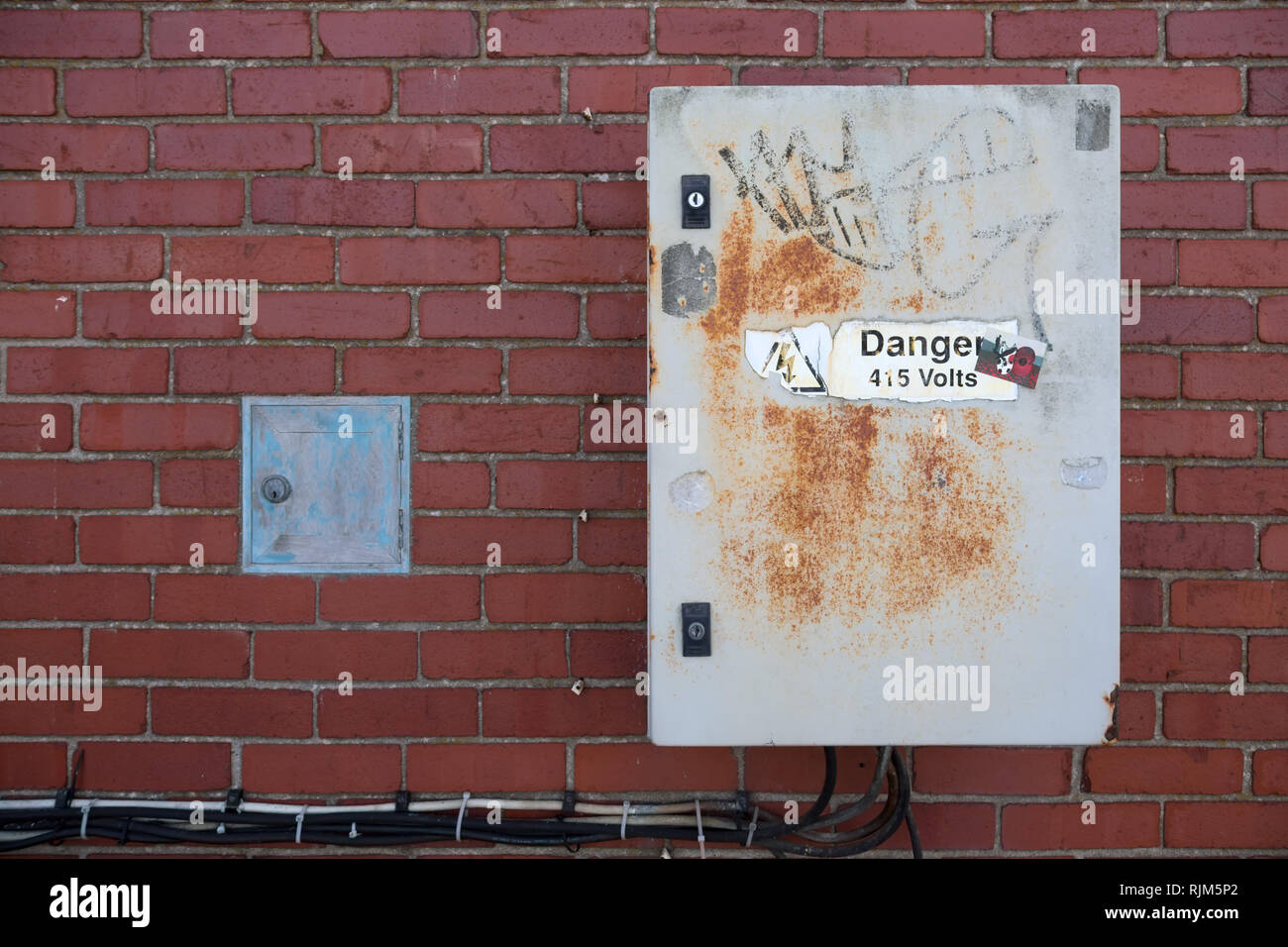 Sign on a brick wall with the letters for danger Stock Photo - Alamy