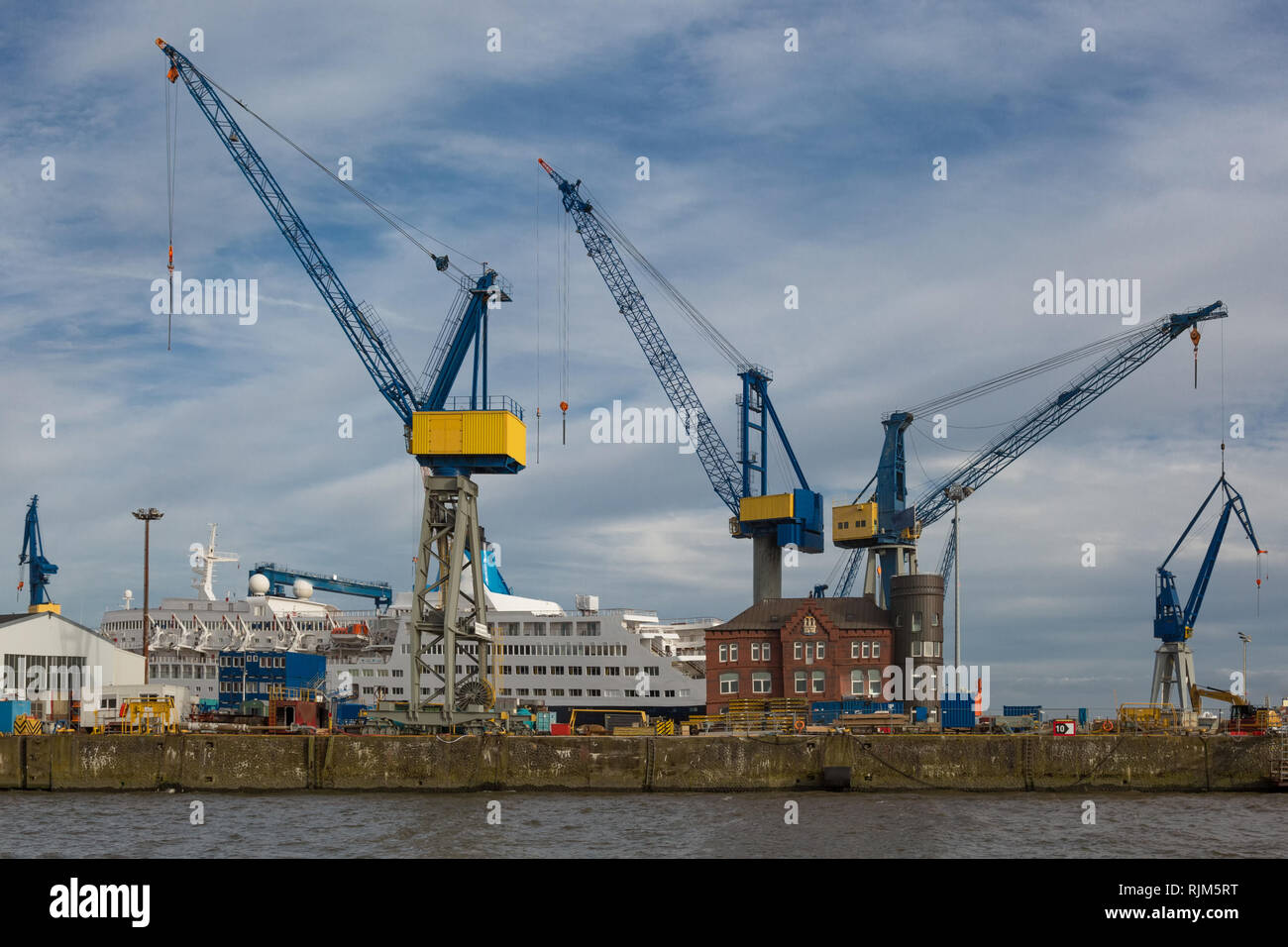 Harbor cranes at work at a shipyard in the harbor Stock Photo - Alamy