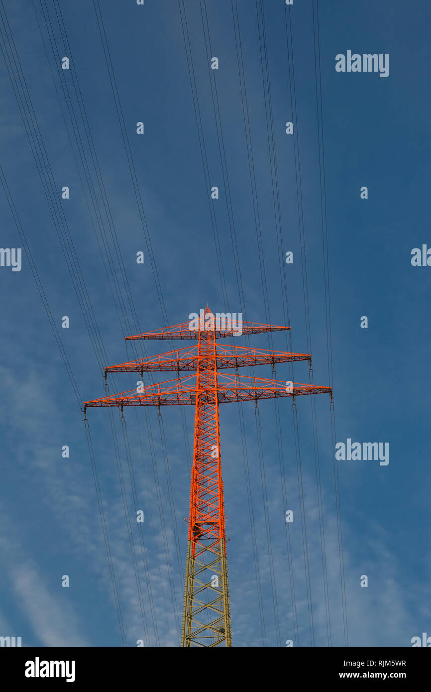 Red power pole with power lines juts in the sky Stock Photo - Alamy