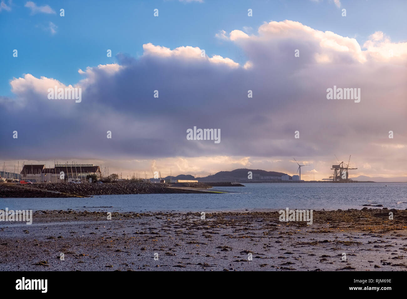 Largs Foreshore looking into the marina across a small bay at low tide ...