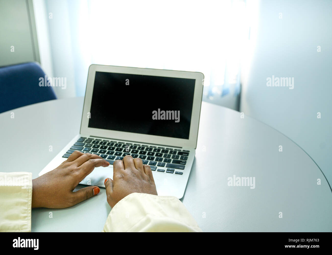 Hands on laptop with black screen for text - in an office room Stock ...