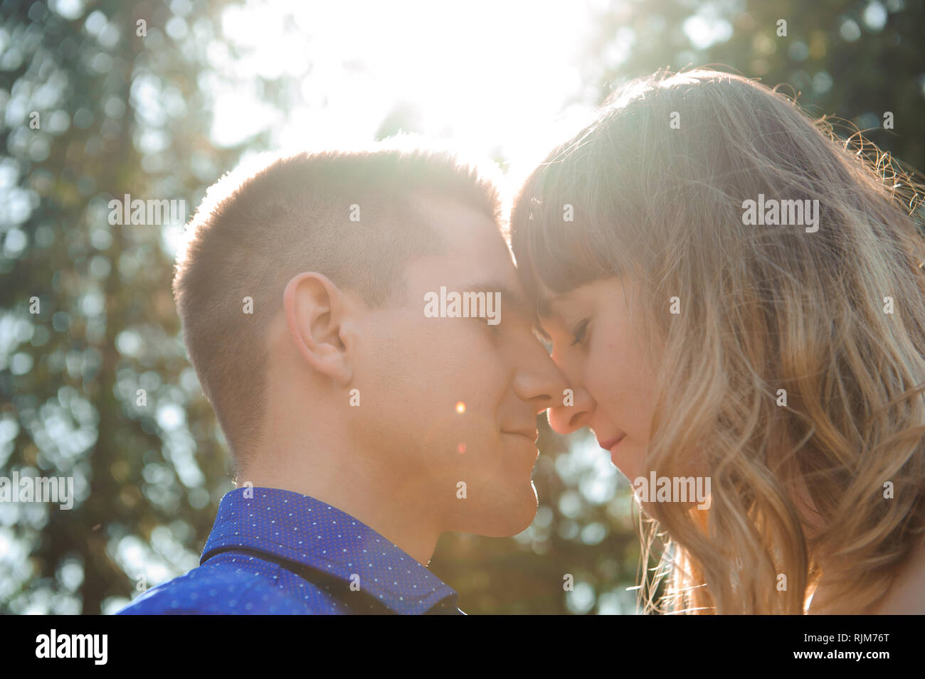 Portrait of young couple in love in a park Stock Photo - Alamy