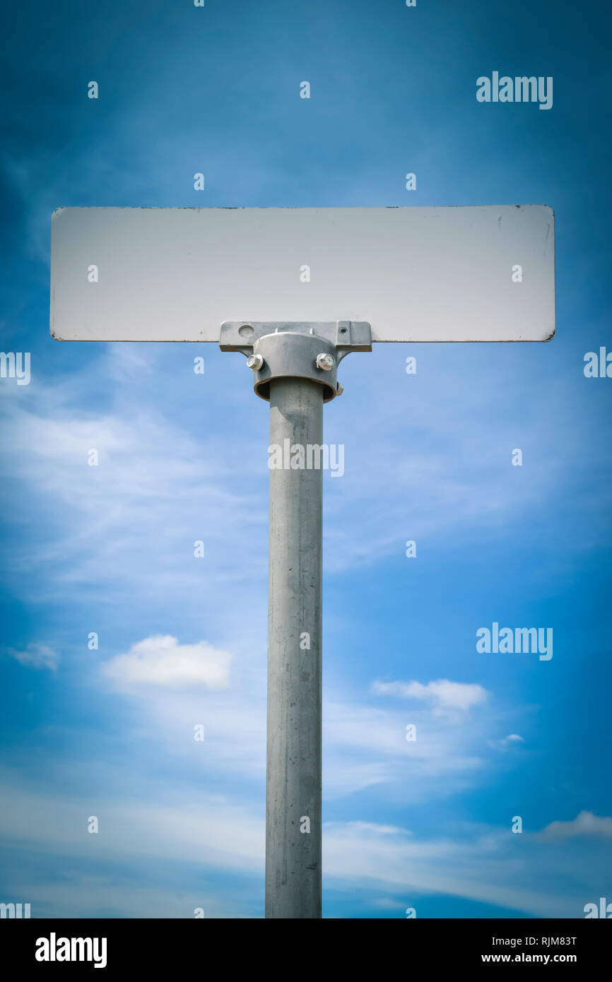 A mysterious no name metal sign on a post, similar to a street name ...