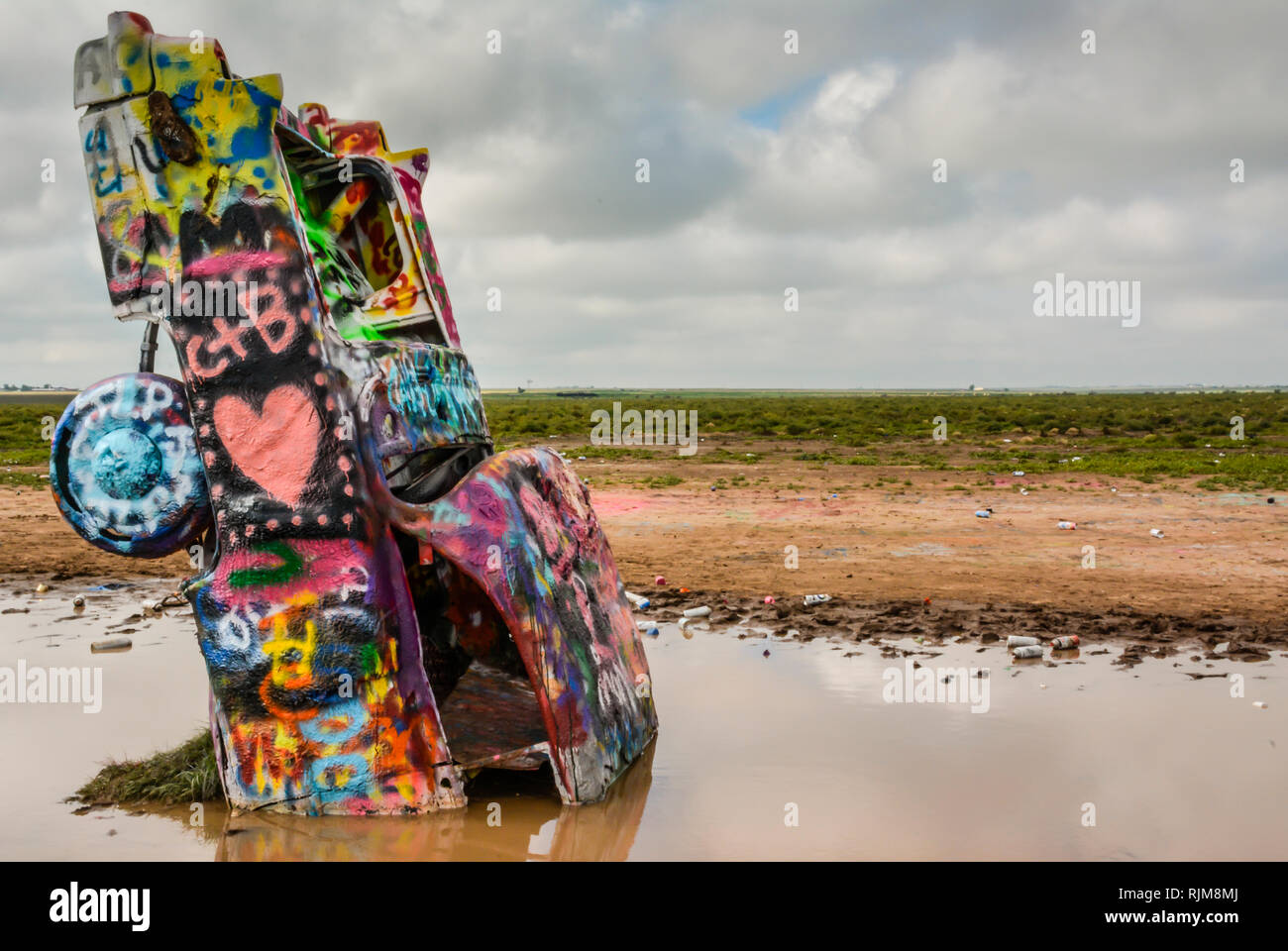 Cadillac Ranch is an art installation comprised of old Cadillacs half ...