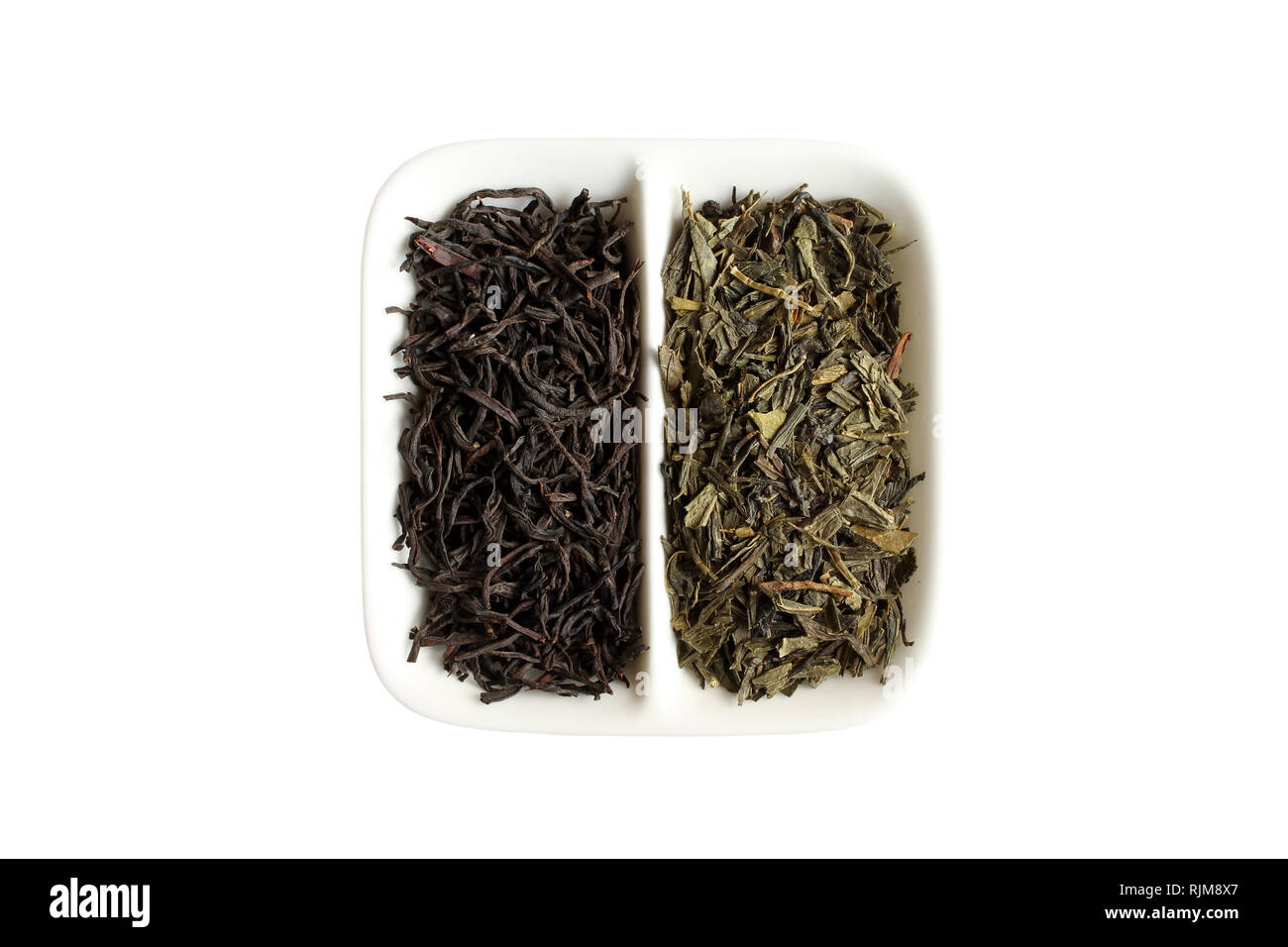 Green tea and black tea in square white saucer on white background ...